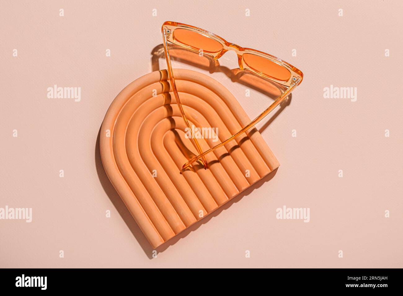 Decorative podium with stylish sunglasses on pink background Stock ...