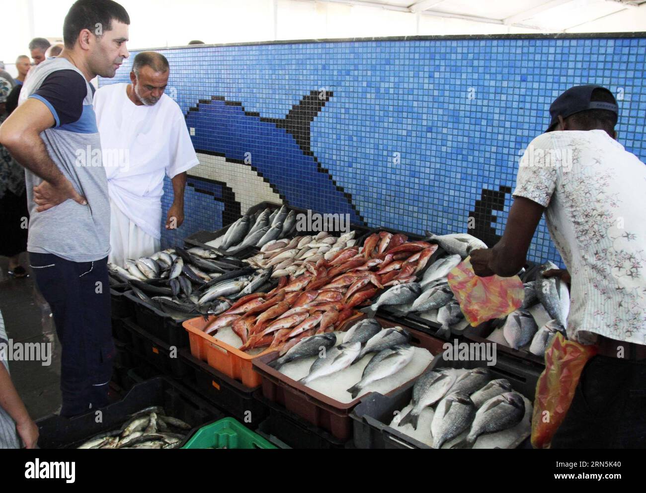 Tripoli citizens buy fish at a fish market before break their fast in ...