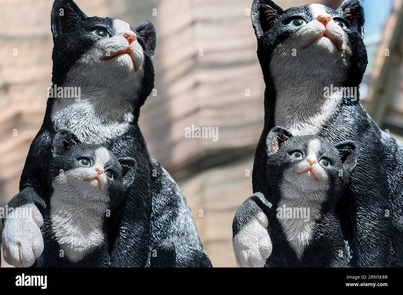 Artificial cats with kittens, as garden decoration in a garden centre ...