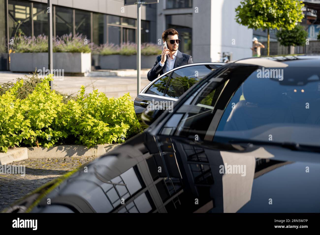 Businessman standing near office building hi-res stock photography and ...