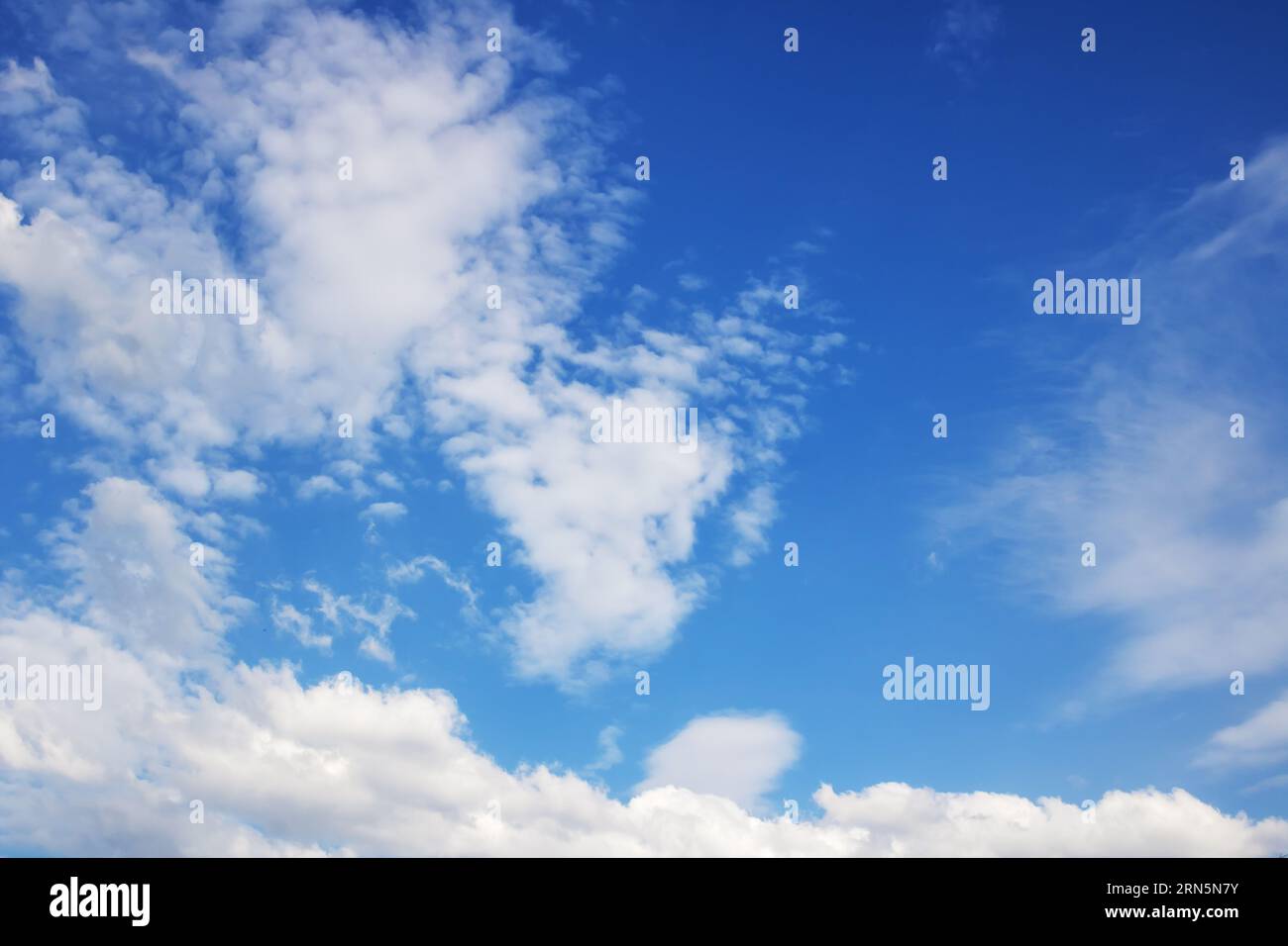 White clouds in bright blue sky close up Stock Photo - Alamy