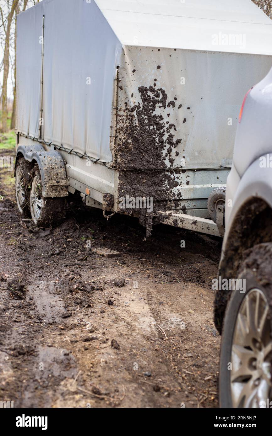 SUV pulls a dirty car trailer off-road. Transportation of goods Stock ...