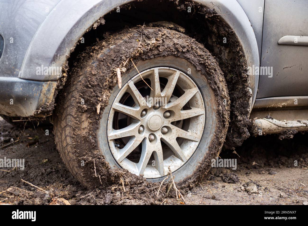 Car tire covered with mud. Driving in the rainy season off-road, bad ...