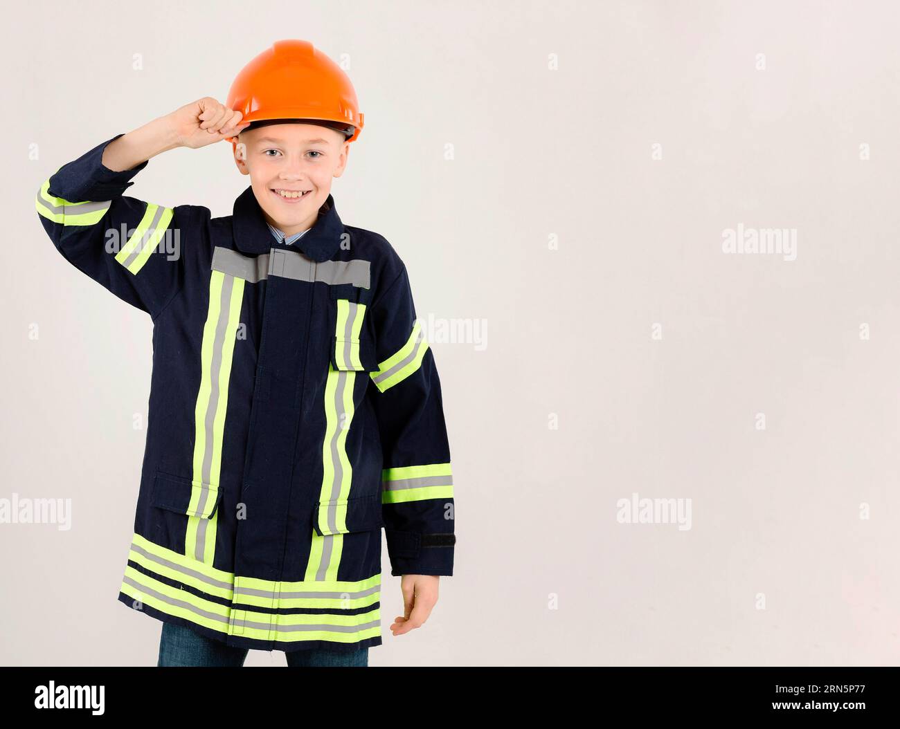 Adorable young fireman copy space Stock Photo - Alamy