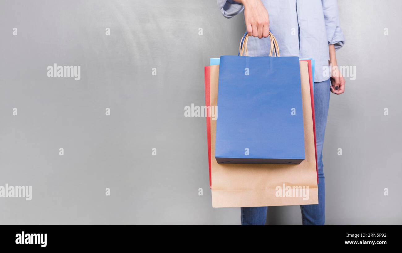Human holding shopping packages Stock Photo - Alamy