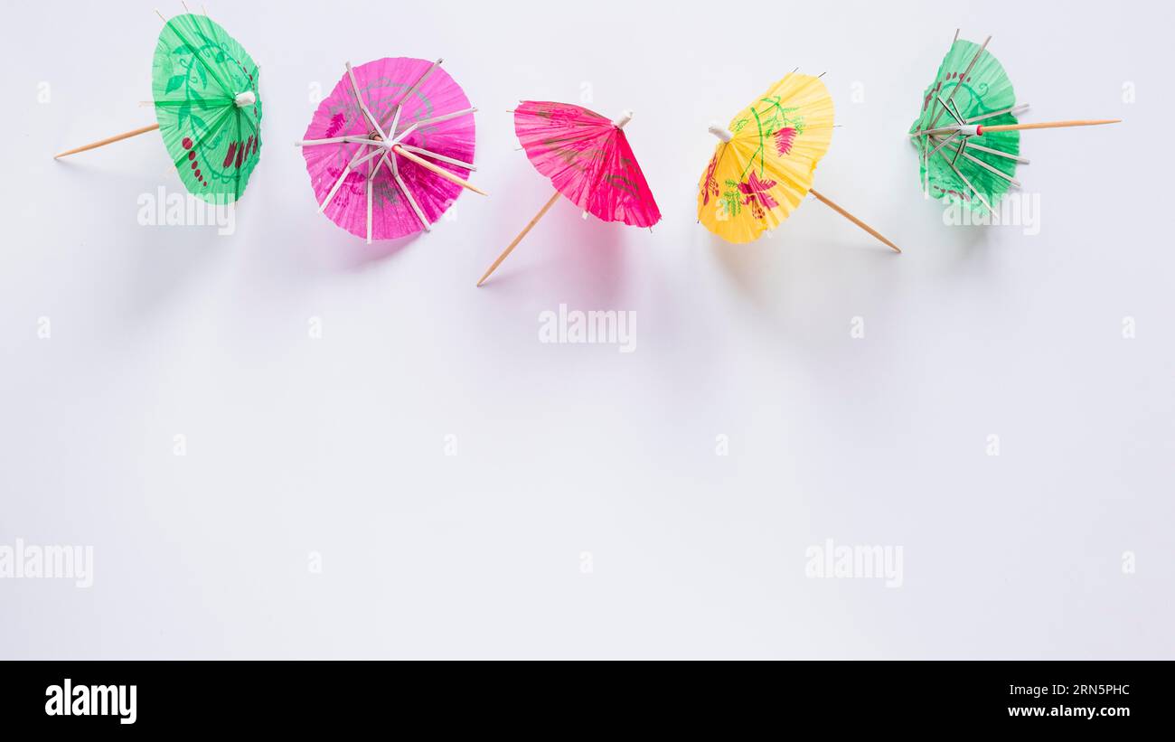 Bright cocktail umbrellas table Stock Photo - Alamy