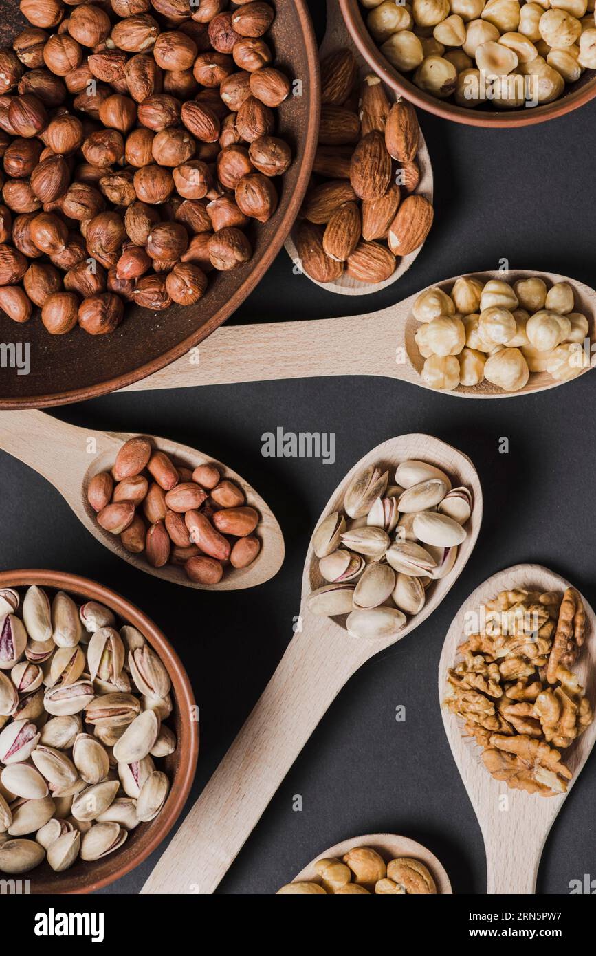 Close up spoons bowls with nuts Stock Photo - Alamy