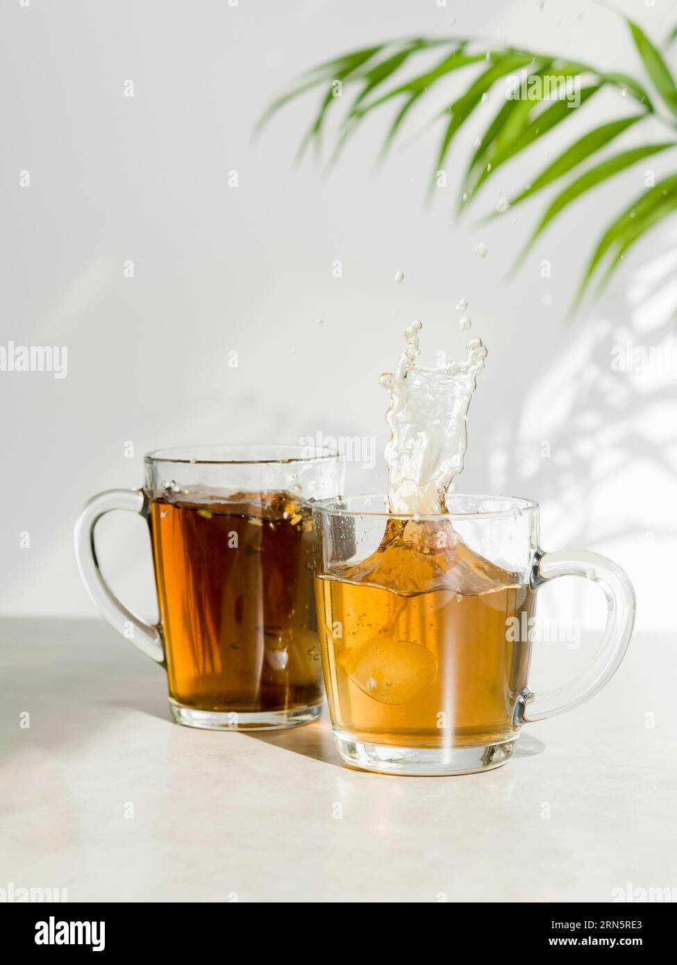 Front view tea splashing glass Stock Photo - Alamy