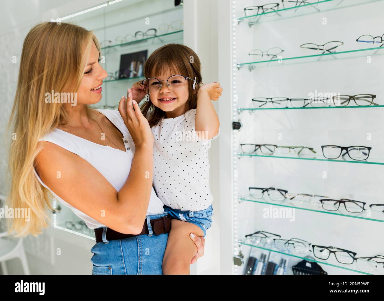 Little girl trying glasses frame Stock Photo - Alamy Little girl trying glasses frame Stock Photo - Alamy