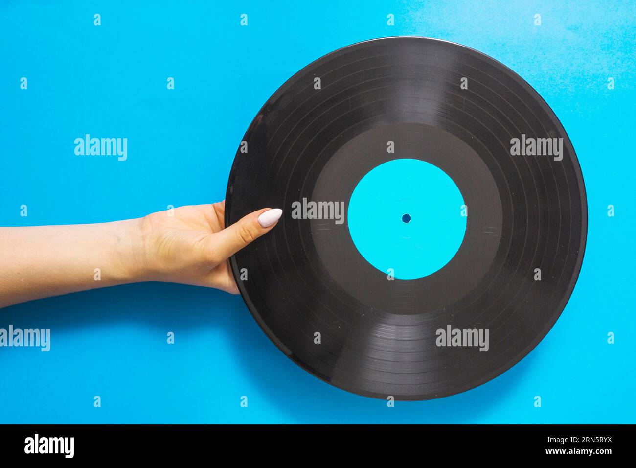Overhead view female hands holding vinyl record blue background Stock ...