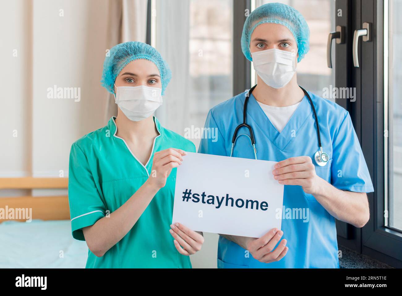 Nurses with stay home message Stock Photo - Alamy