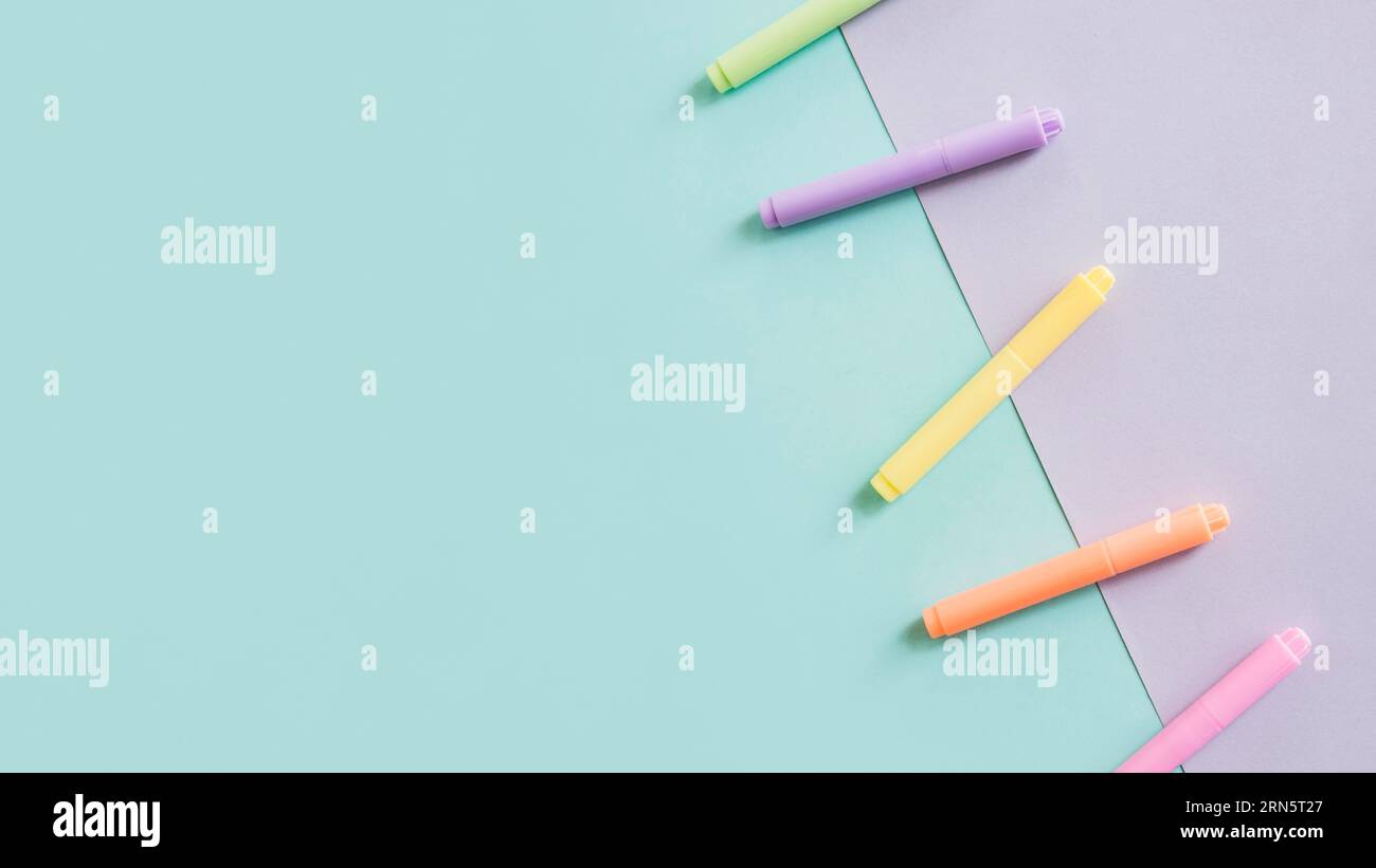 Multi colored markers grey green paper background Stock Photo - Alamy