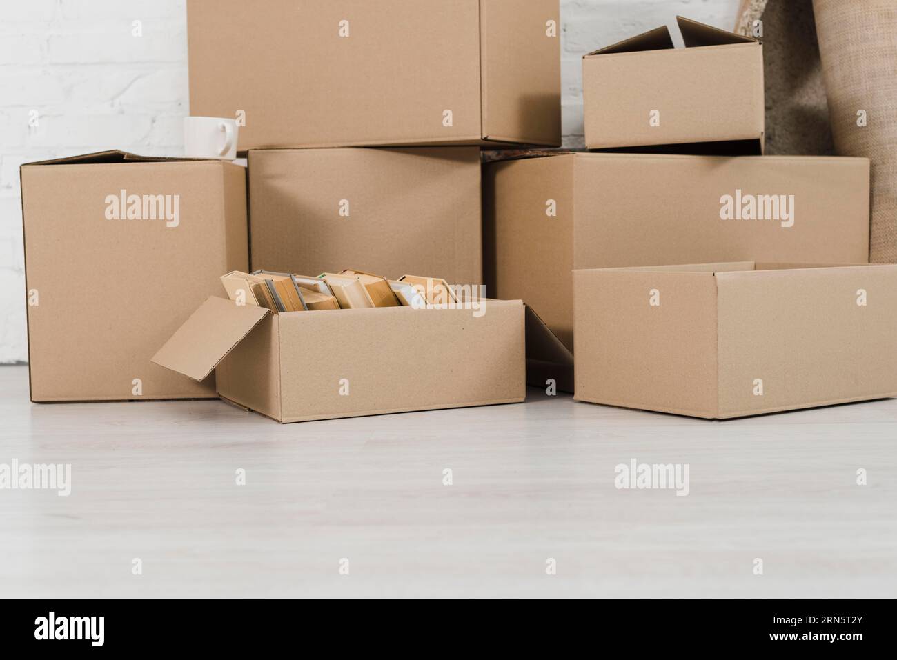 Pile cardboard boxes white floor Stock Photo - Alamy