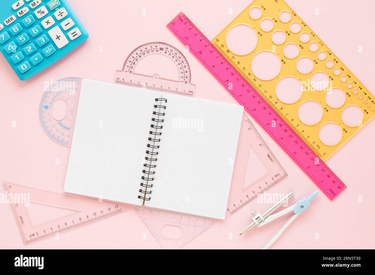 Math rulers supplies with open empty notebook flat lay Stock Photo - Alamy