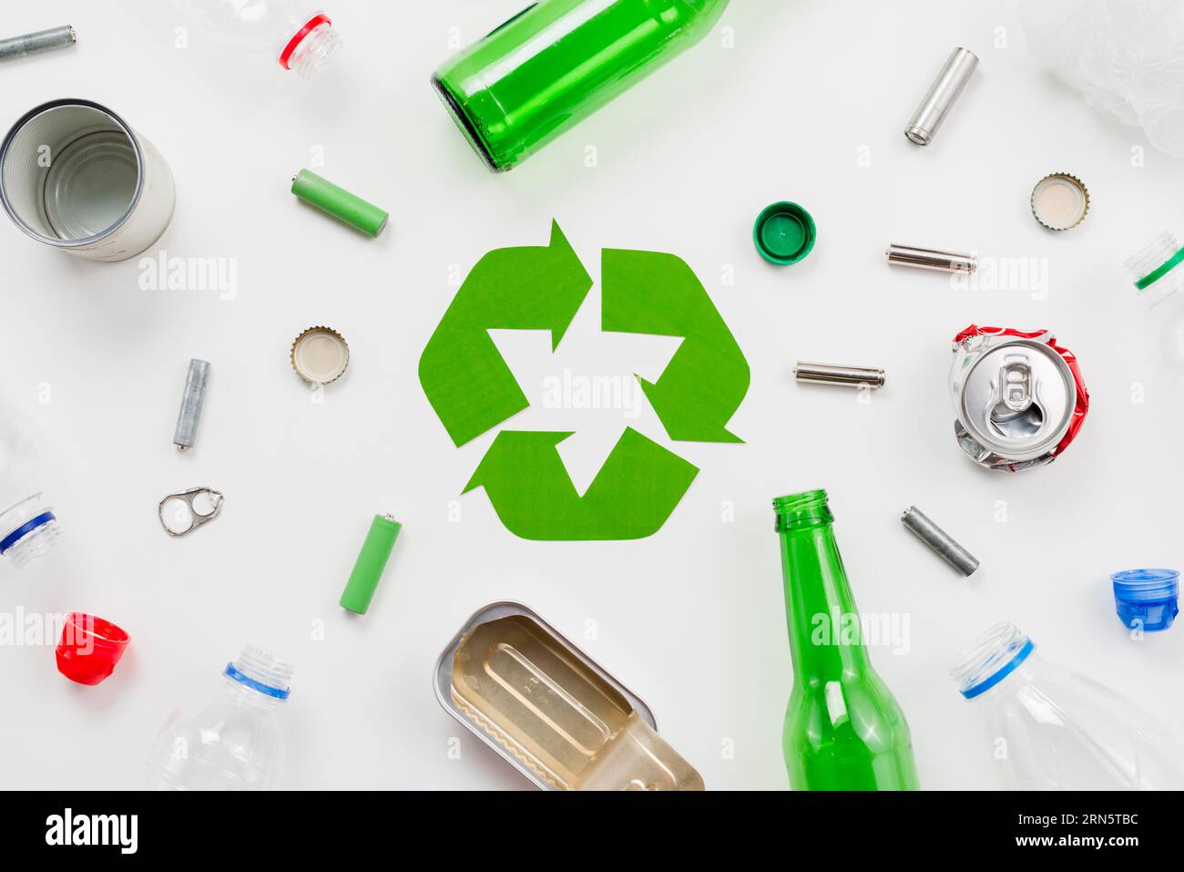 Recycling emblem around different trash Stock Photo - Alamy