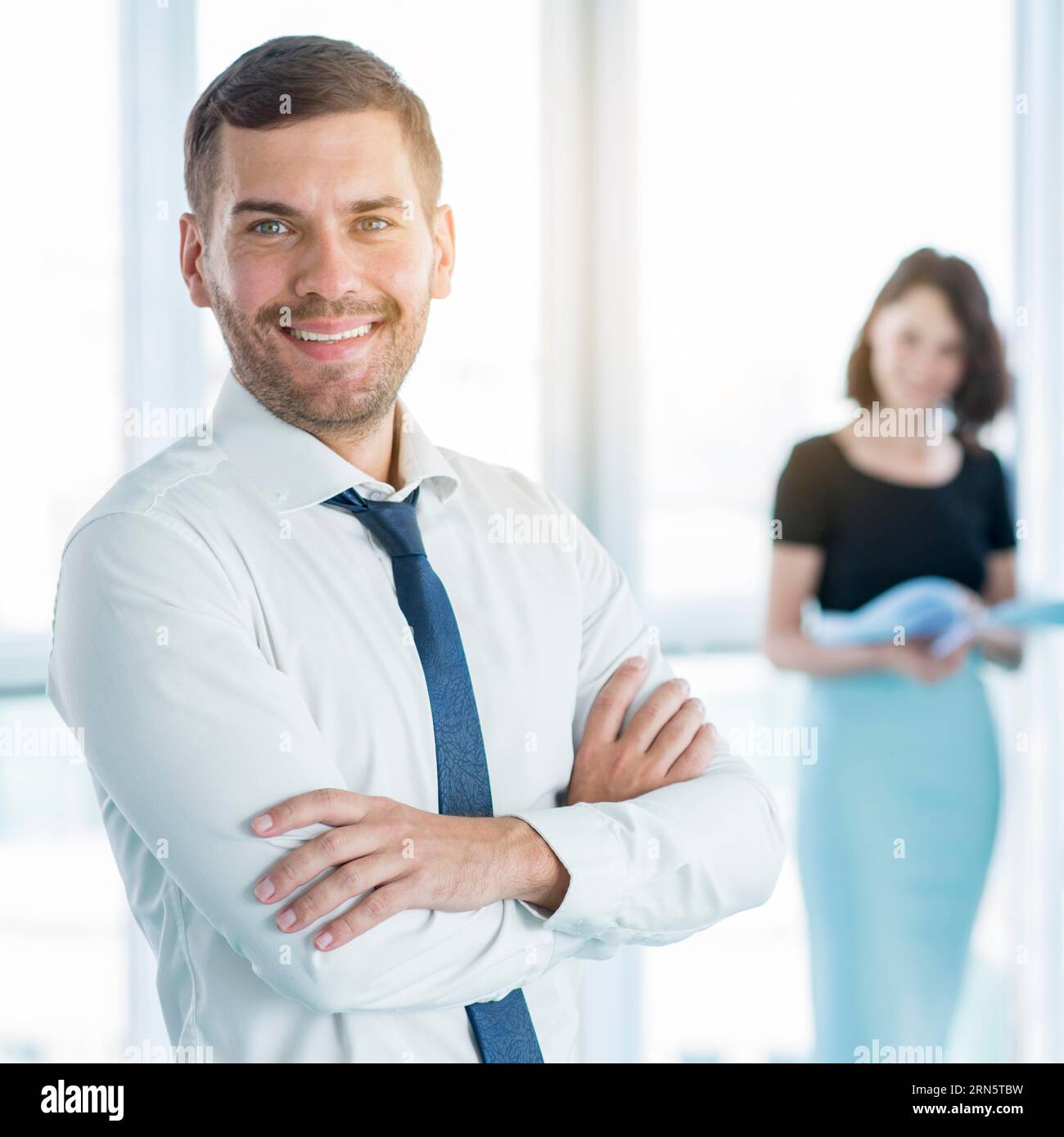 Portrait happy businessman with folded arms Stock Photo - Alamy