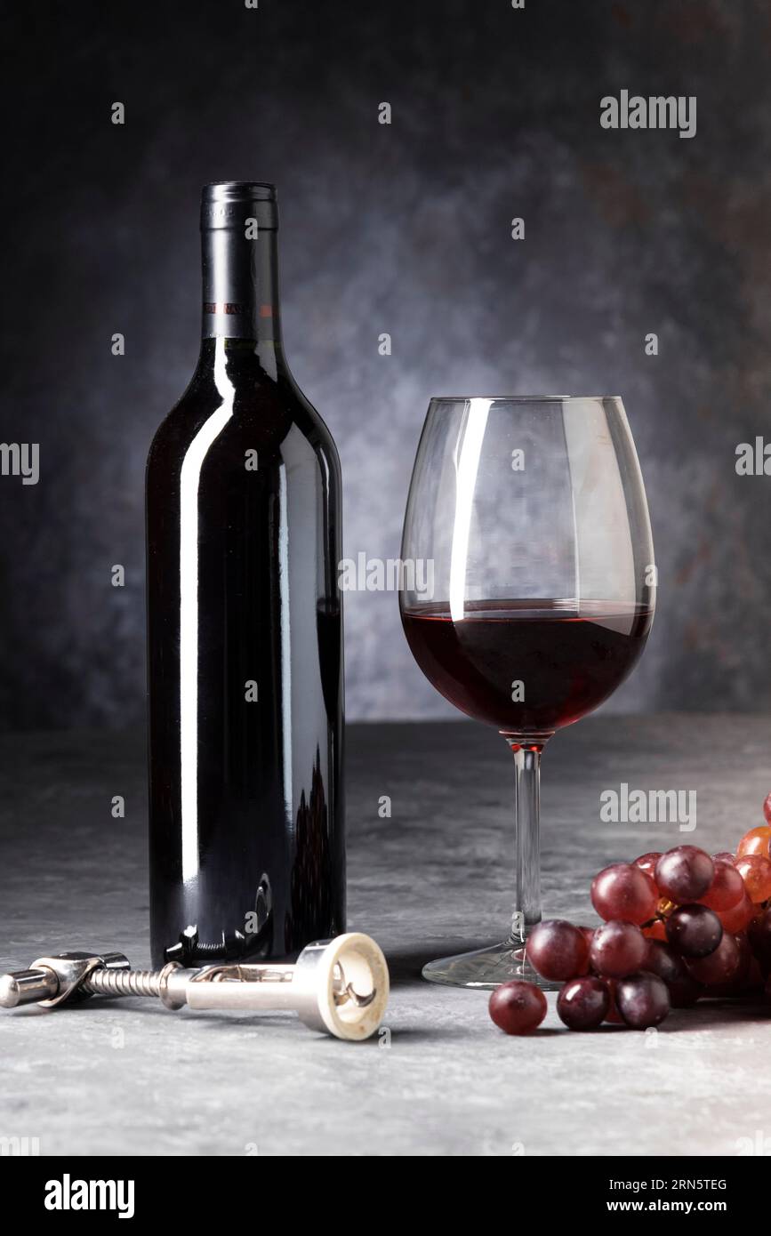 Red bottle wine half empty glass Stock Photo - Alamy