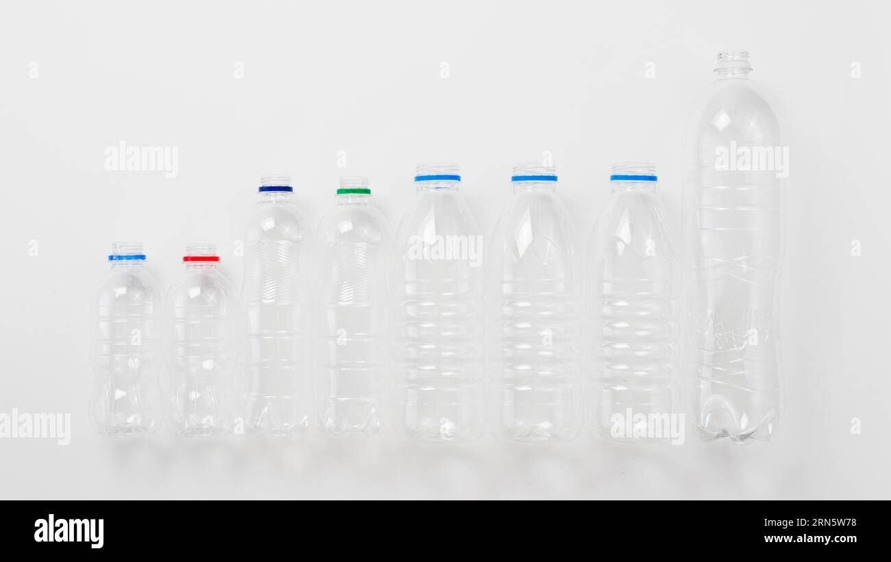 Various types plastic bottles grey background Stock Photo - Alamy