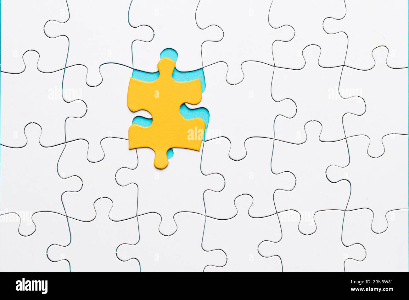 Yellow puzzle piece with white grid puzzle Stock Photo - Alamy