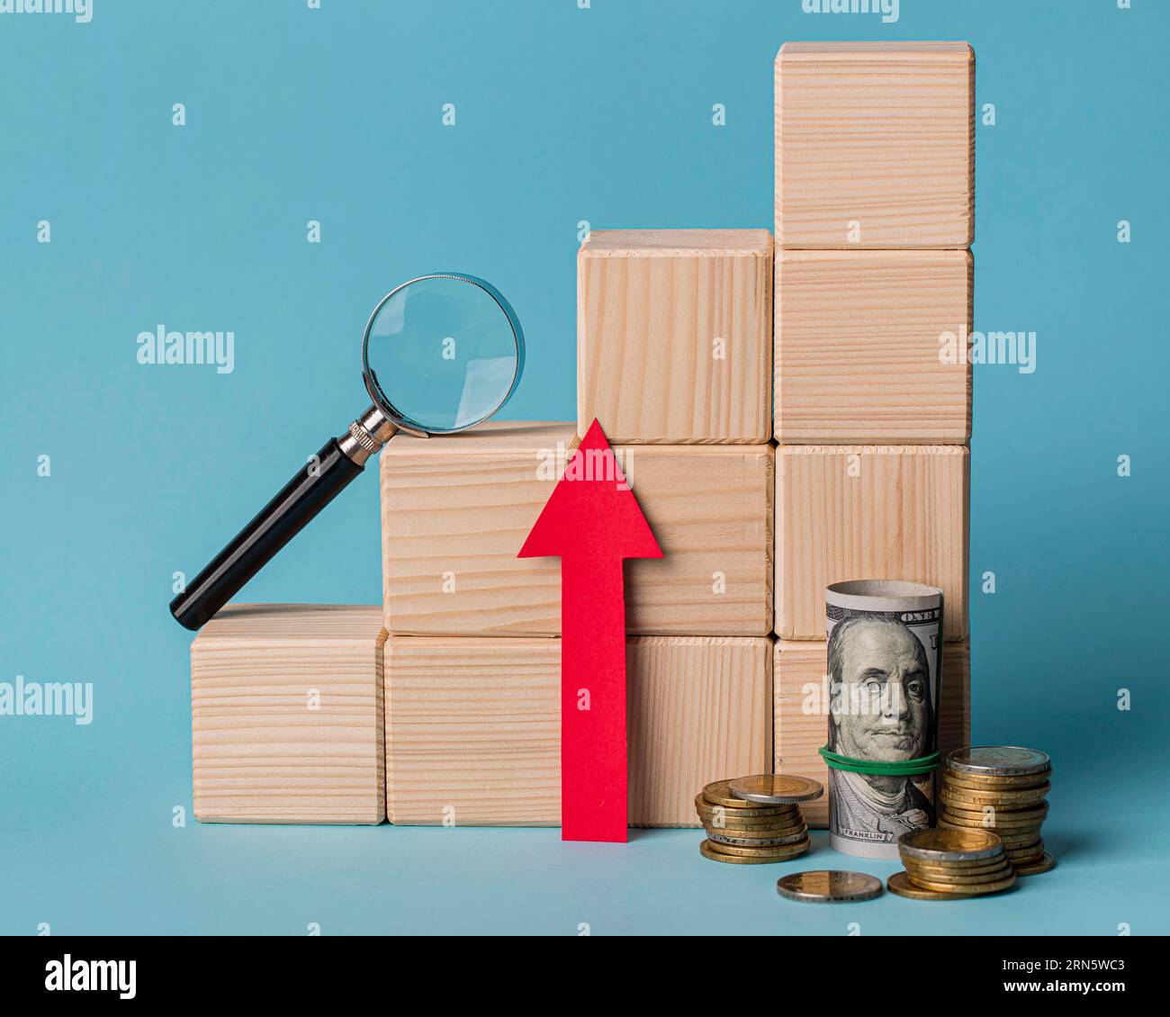 Wooden blocks with magnifying glass growth arrow Stock Photo - Alamy