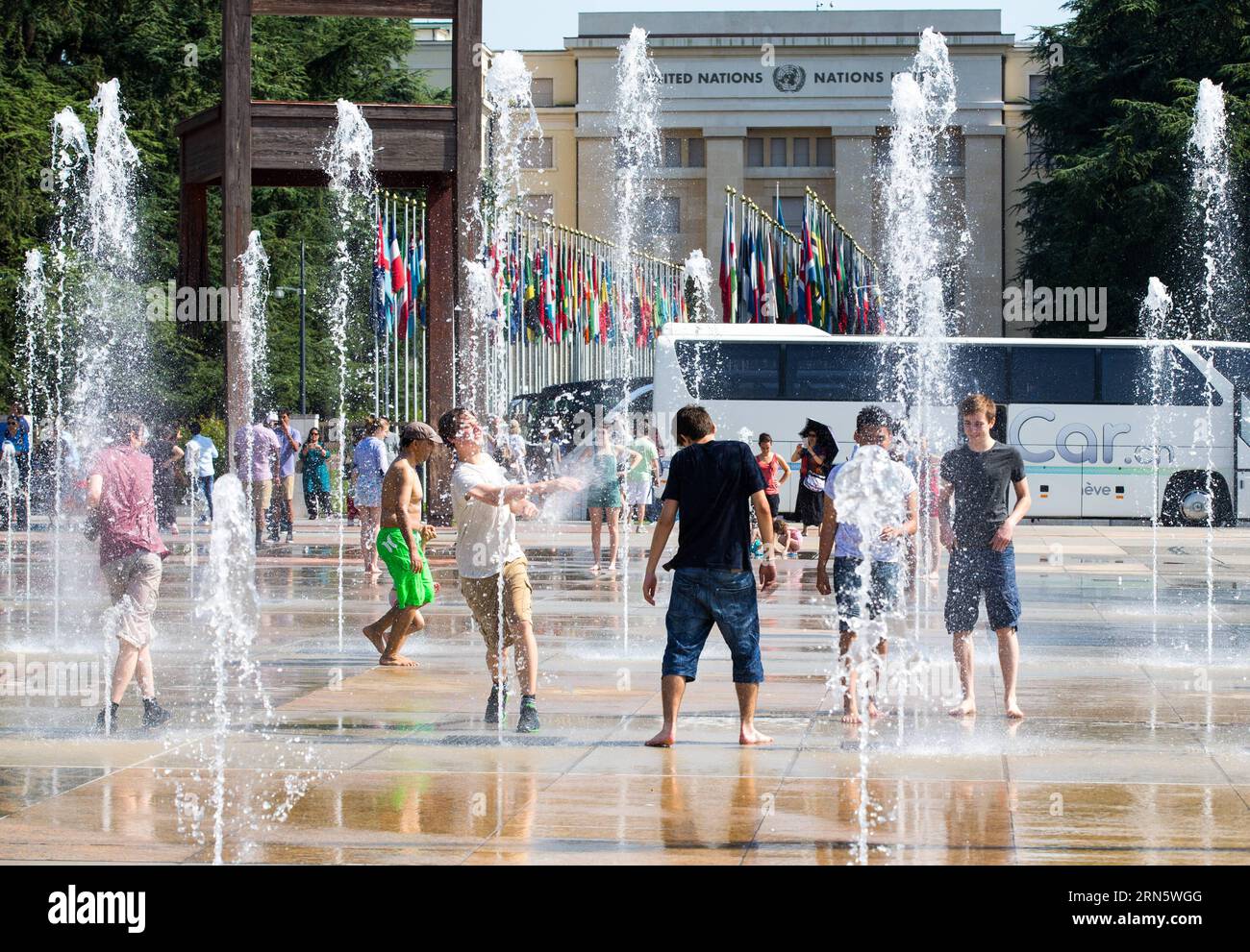 (150704) -- GENEVA, July 4, 2015 -- People cool off in fountains on ...