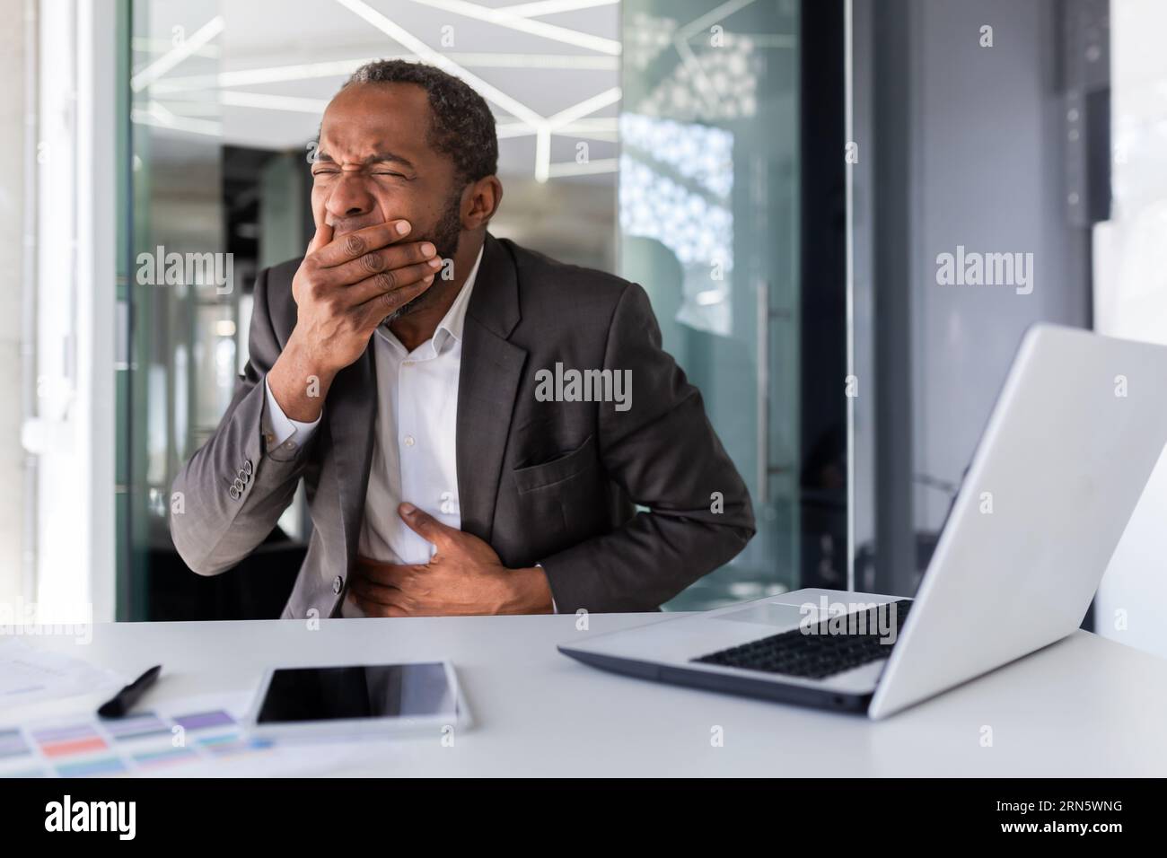Sick man at workplace inside office, african american man got food ...