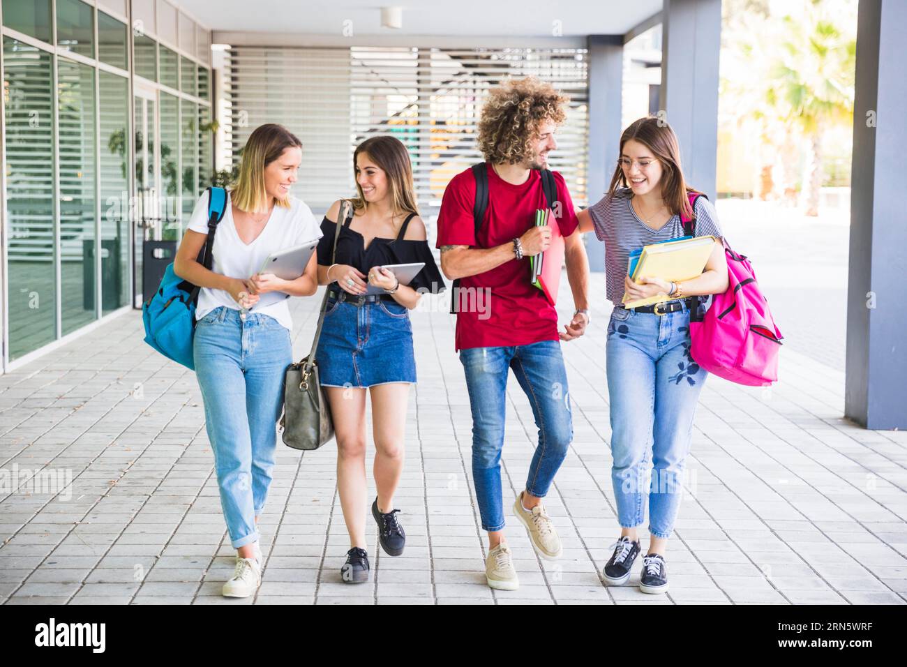 Cheerful students communicating after lessons Stock Photo - Alamy
