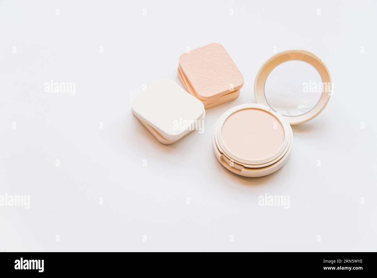 Close up cosmetic realistic plastic compact powder with sponges white ...