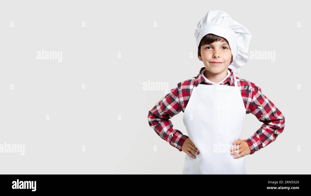 Cute young boy posing as chef Stock Photo - Alamy