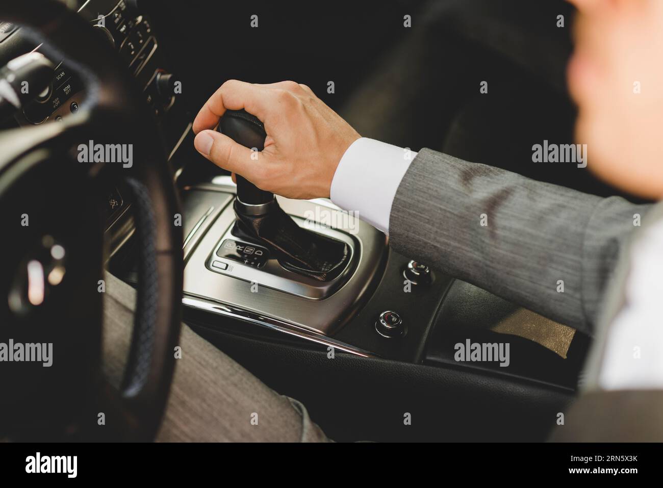 Elevated view businessman driving car moving transmission shift gear ...