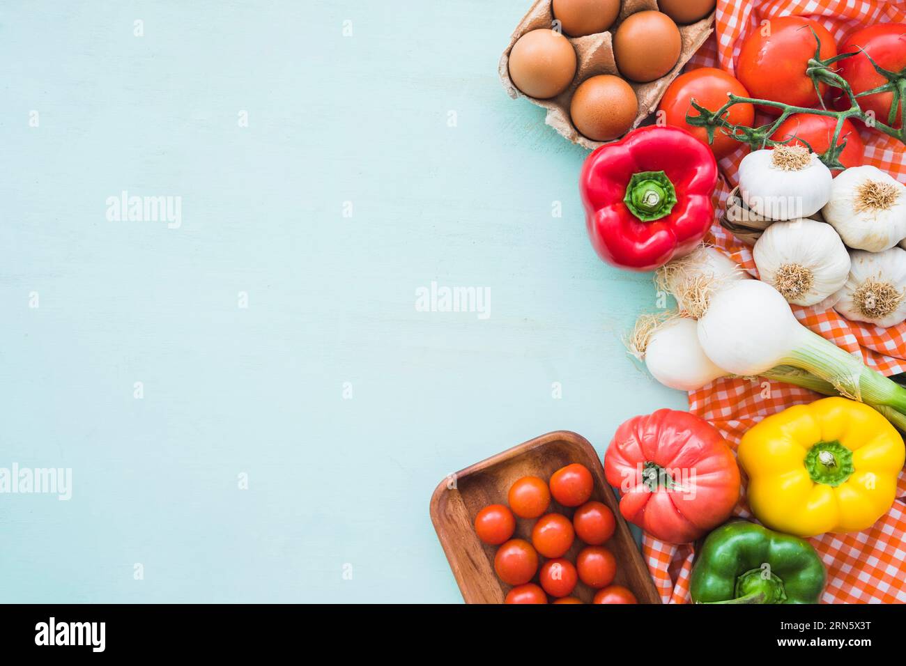 Eggs healthy vegetables blue colored background Stock Photo - Alamy