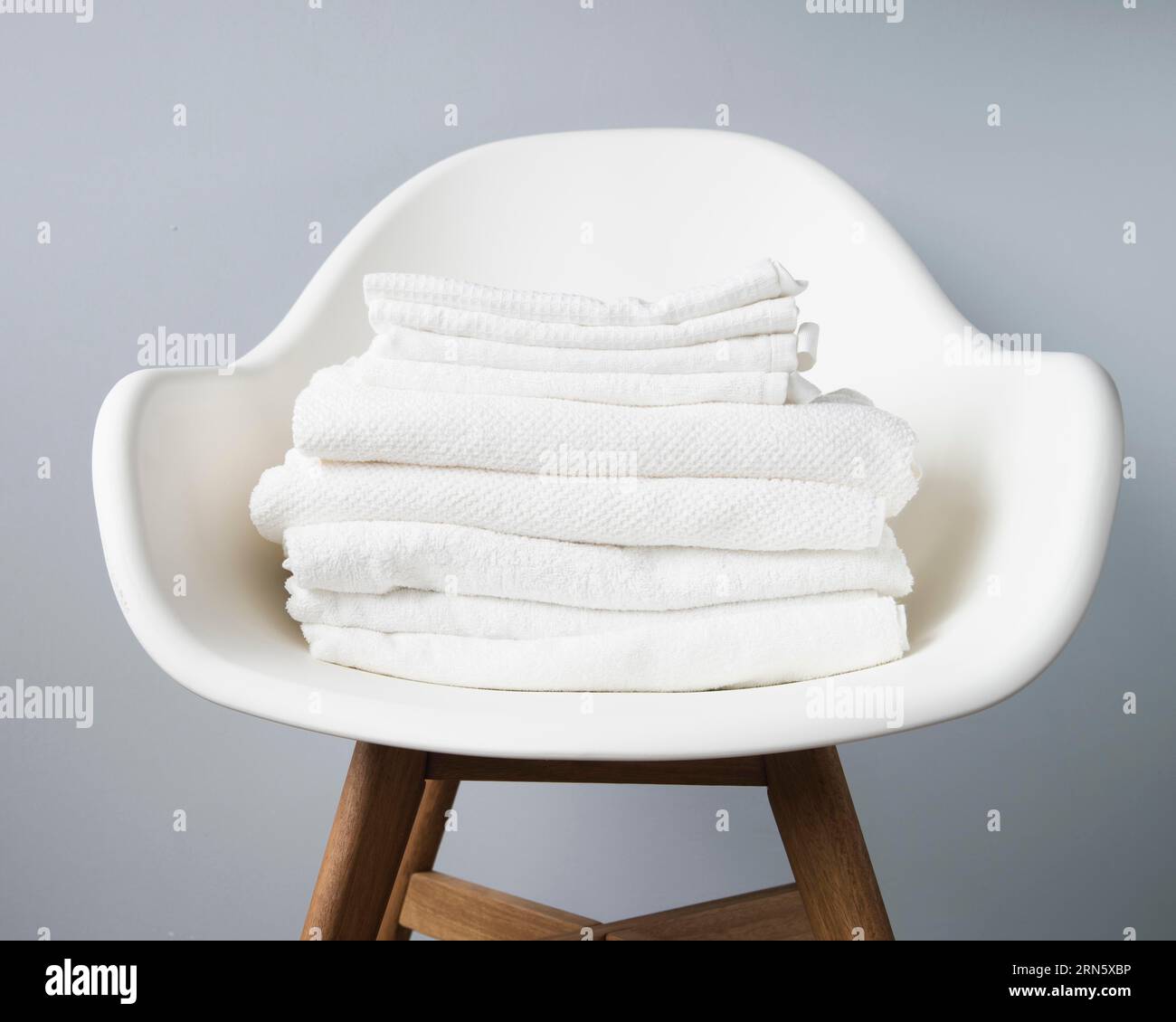 Laundry stacked on chair hi-res stock photography and images - Alamy
