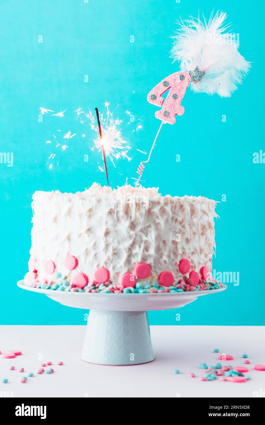 Fourth birthday cake with burning sparkler white surface Stock Photo ...
