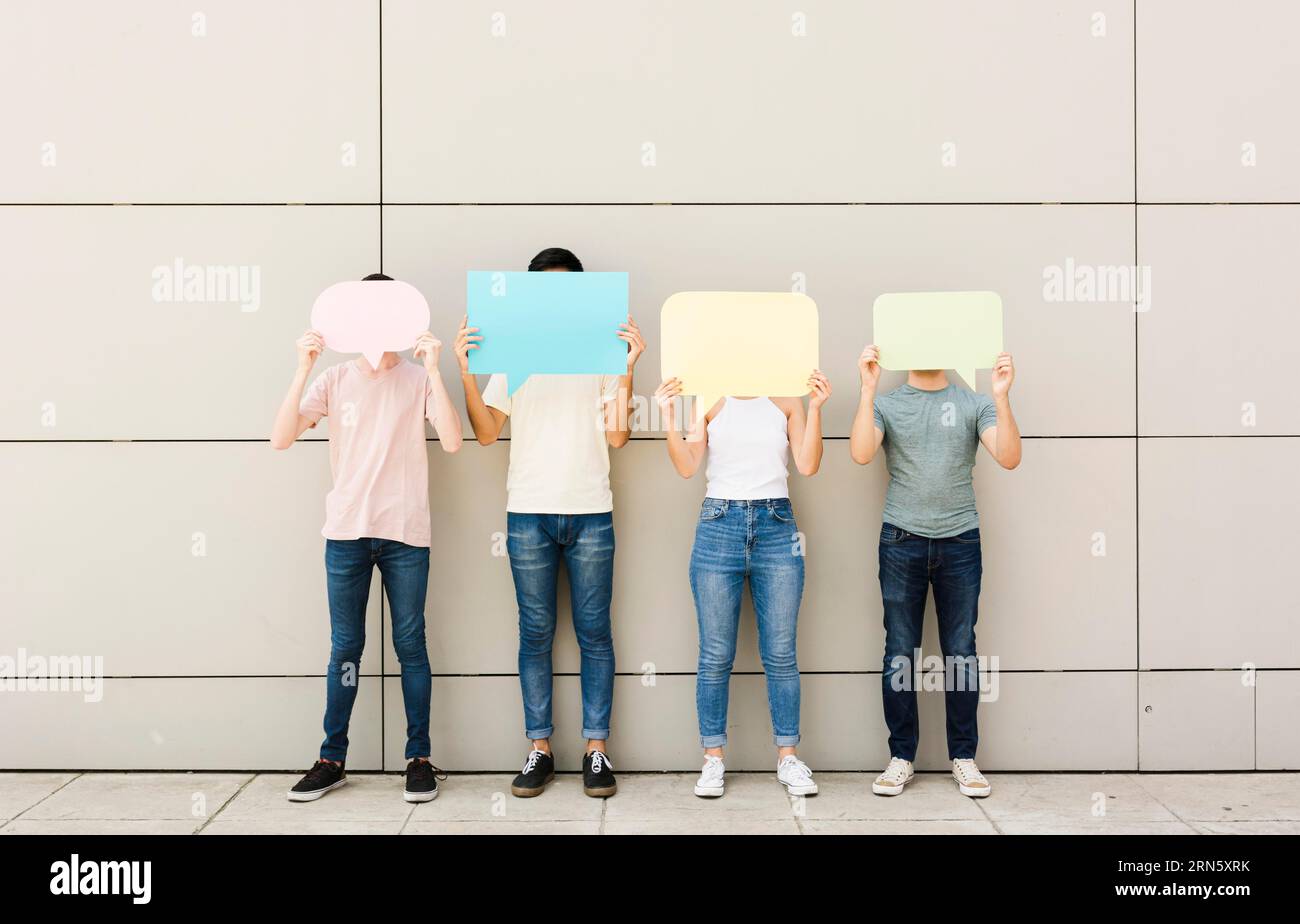 Group friends holding speech bubbles Stock Photo - Alamy