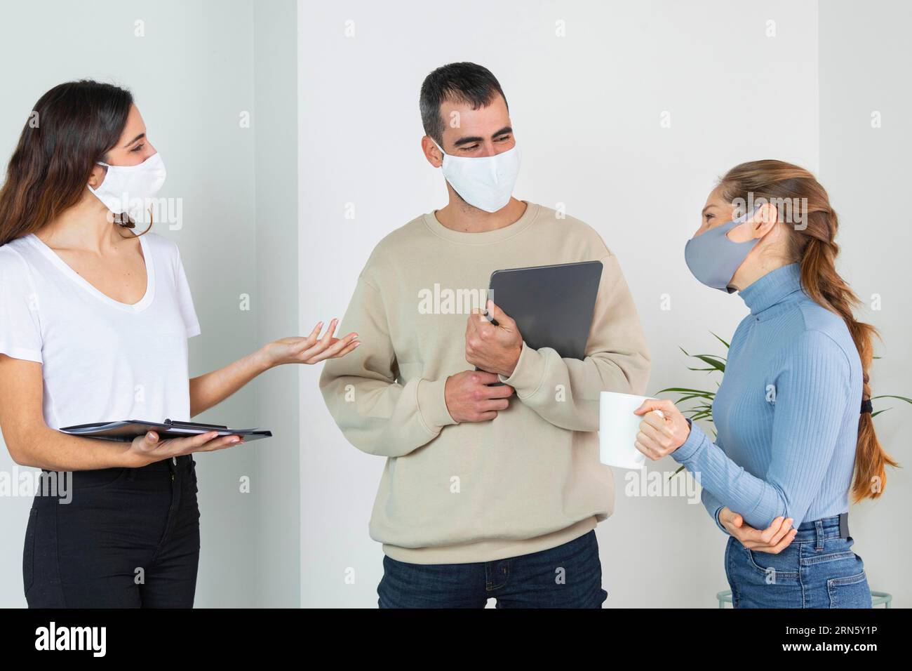 Medium shot people talking work Stock Photo - Alamy