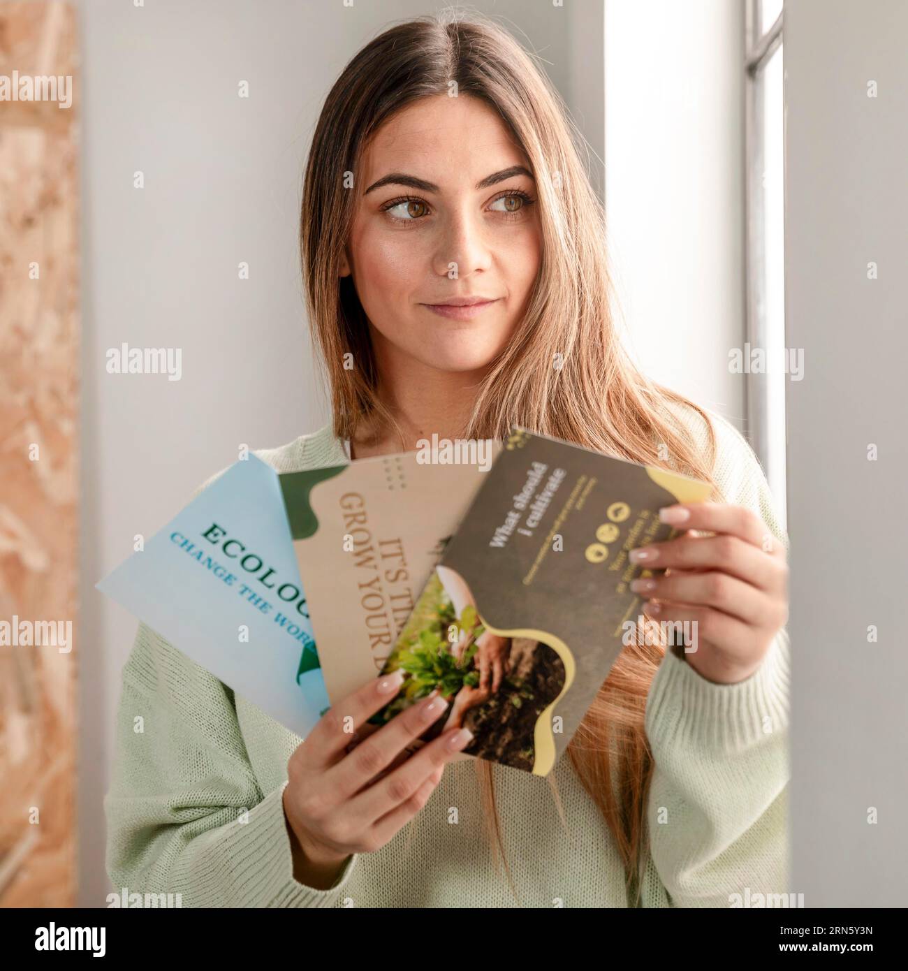 Woman holding flyer page hi-res stock photography and images - Alamy