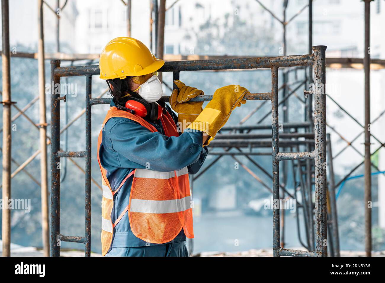 Portrait man with safety equipment side view carrying ladder Stock ...