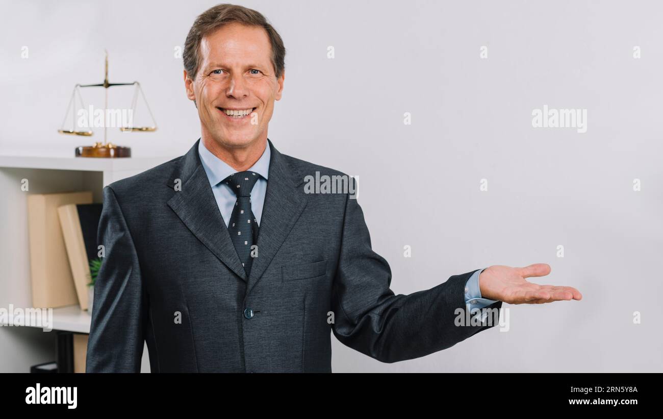 Portrait smiling mature businessman presenting Stock Photo - Alamy Portrait smiling mature businessman presenting Stock Photo - Alamy