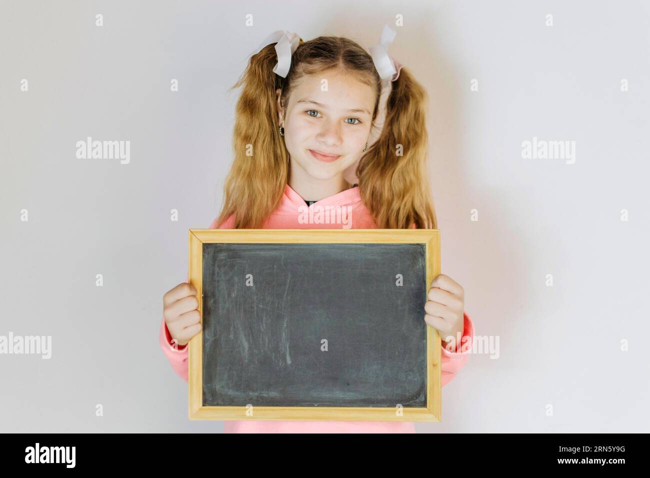 Girl holding slate hi-res stock photography and images - Alamy