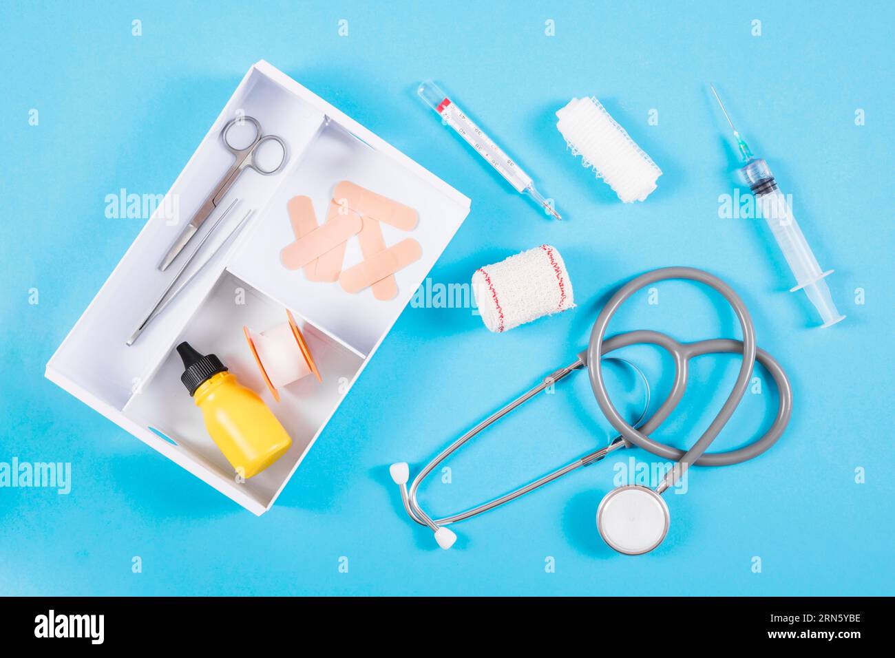 Open first aid kit with medical equipments blue background Stock Photo ...