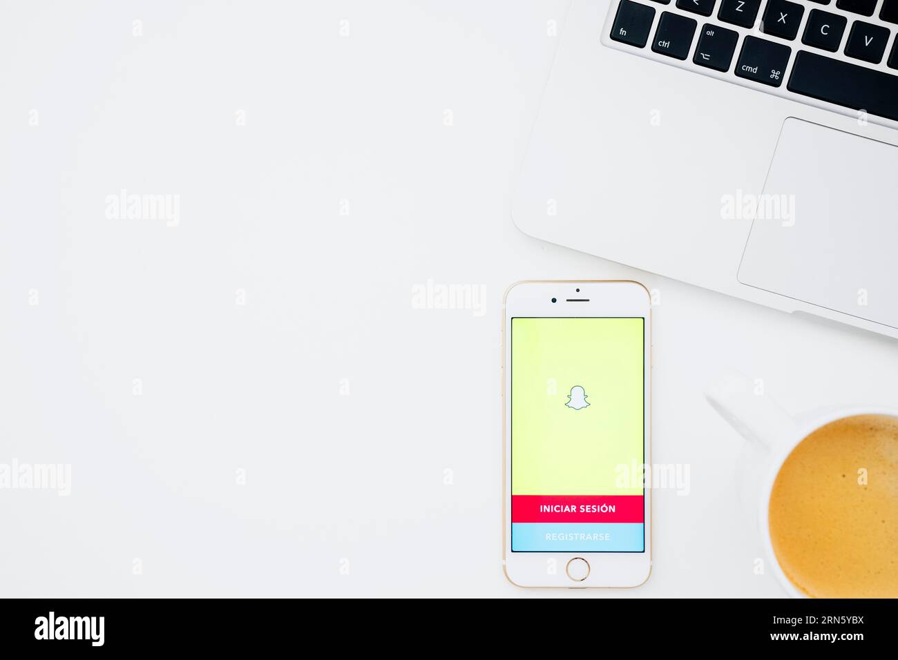 Phone with snapchat app coffee laptop Stock Photo - Alamy
