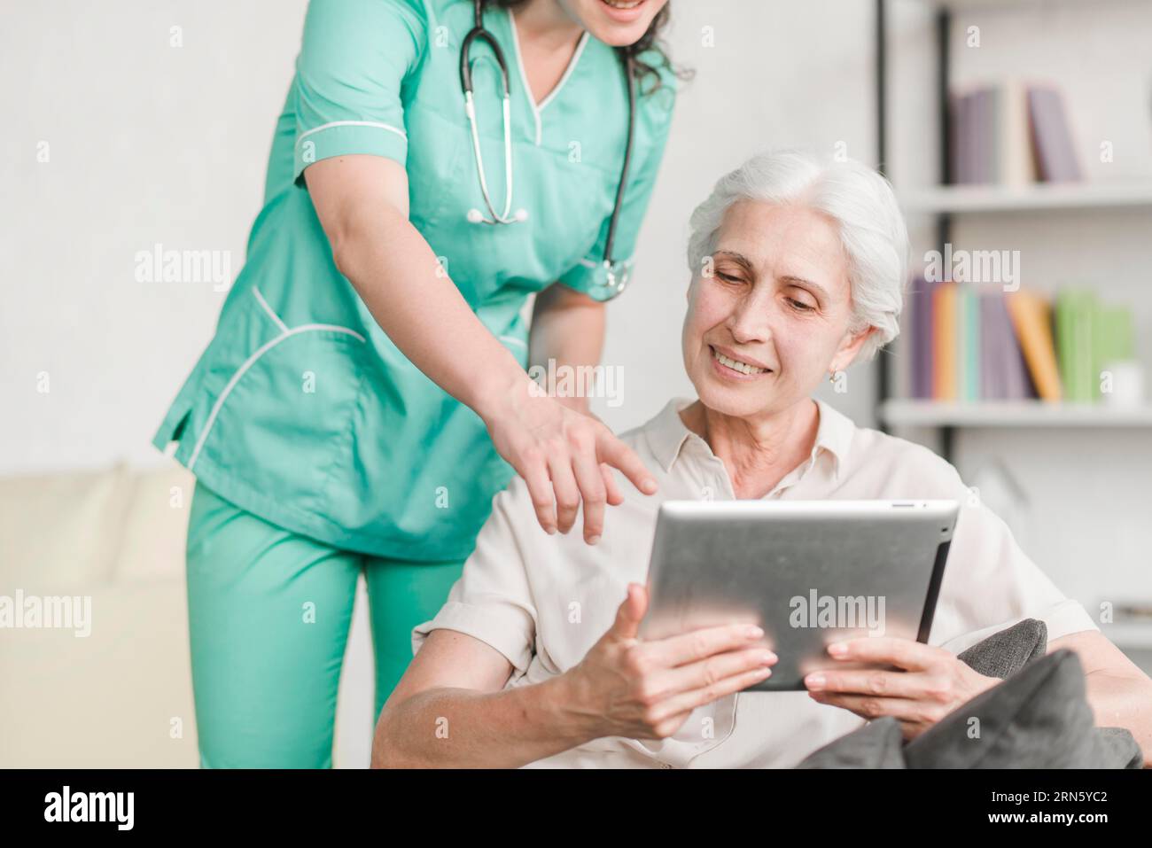 Nurse showing something senior female patient digital tablet Stock ...