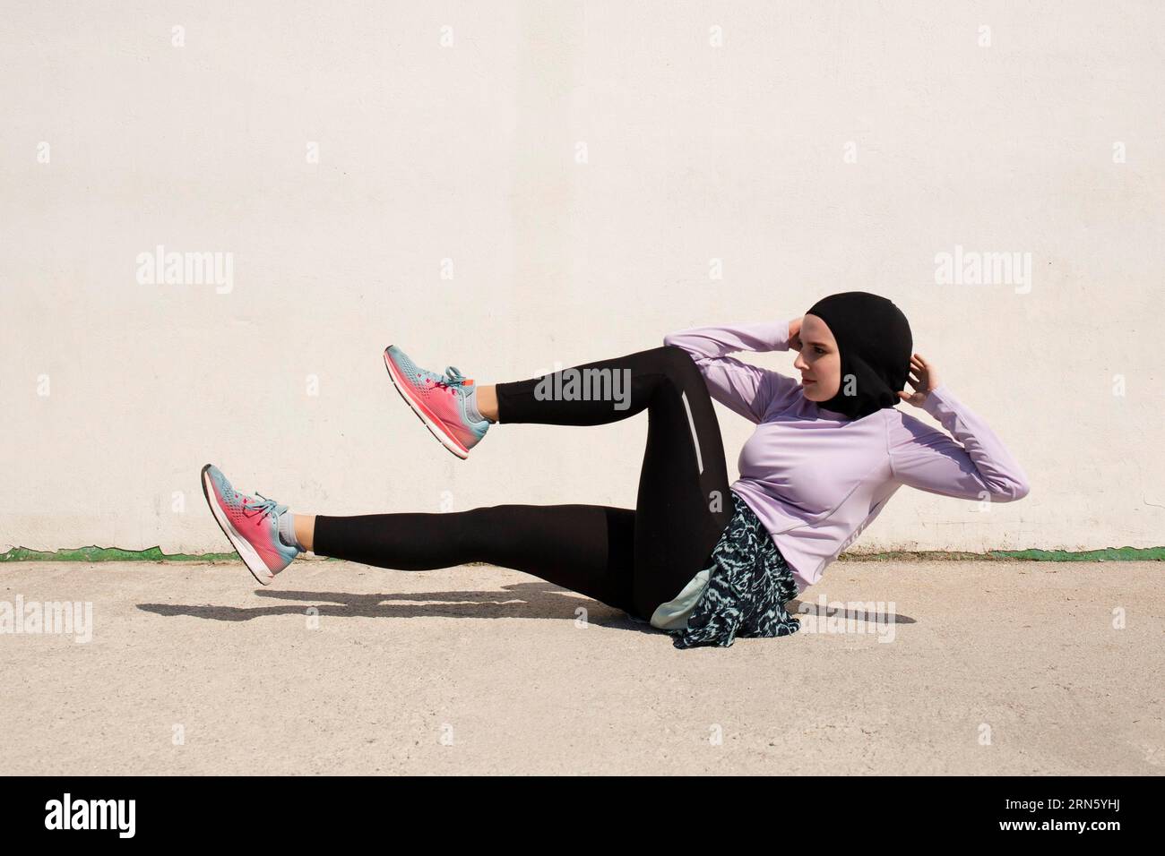 Side view woman doing bicycle kicks Stock Photo - Alamy