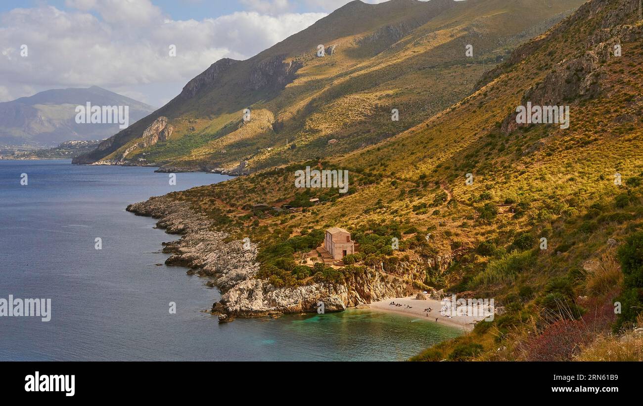 Cloudy weather, coastline, green coastal mountains, small bay, pebble ...