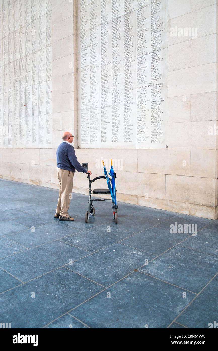 A senior citizen with a walker stands in the Men's Gate, a memorial to ...