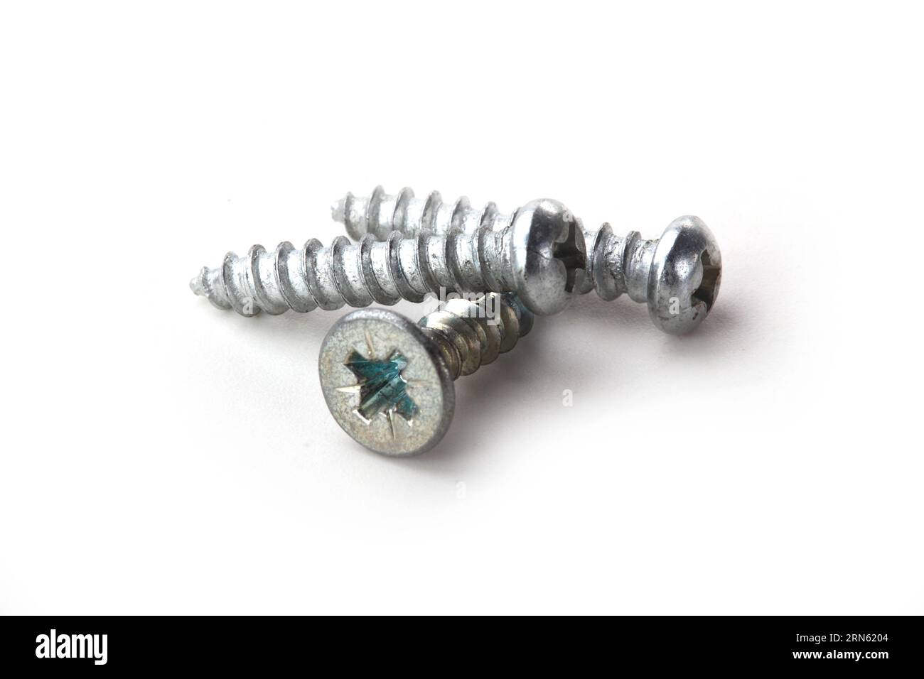 The closeup of many screws isolated on white background Stock Photo - Alamy