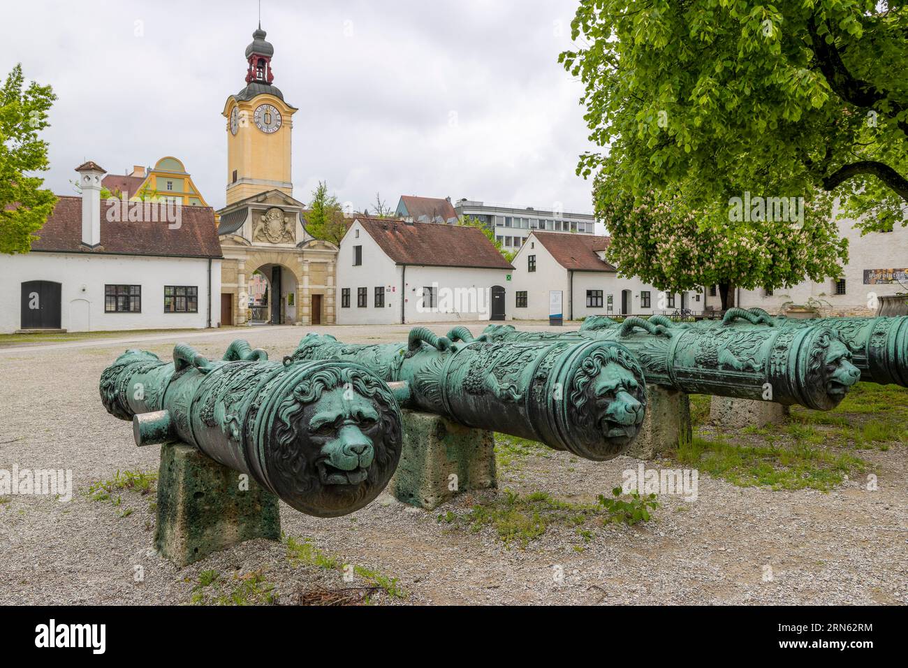 Old cannons and in the background Baroque clock tower at the entrance ...