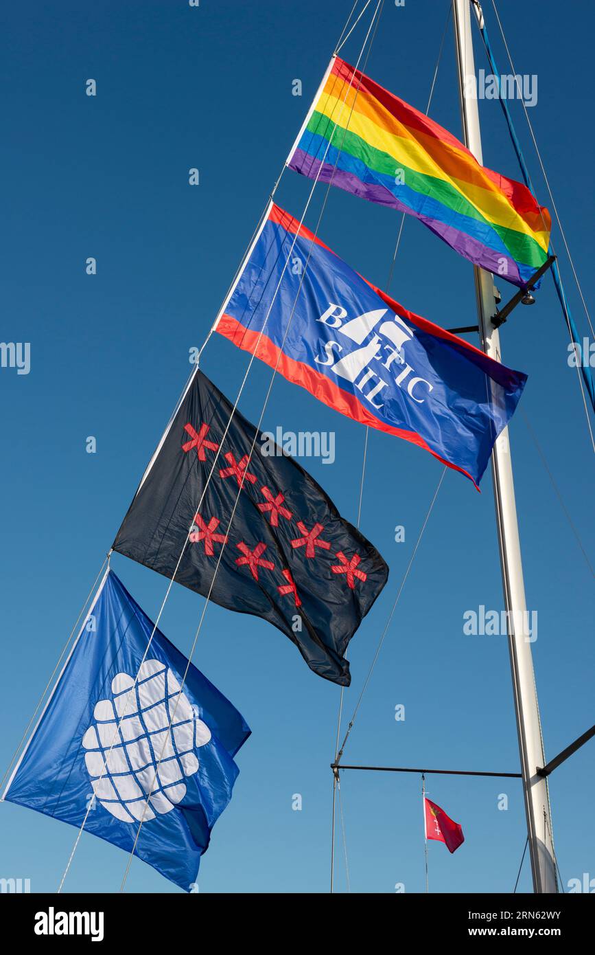 Various colourful flags on sailboat mast during the Baltic Sail event ...