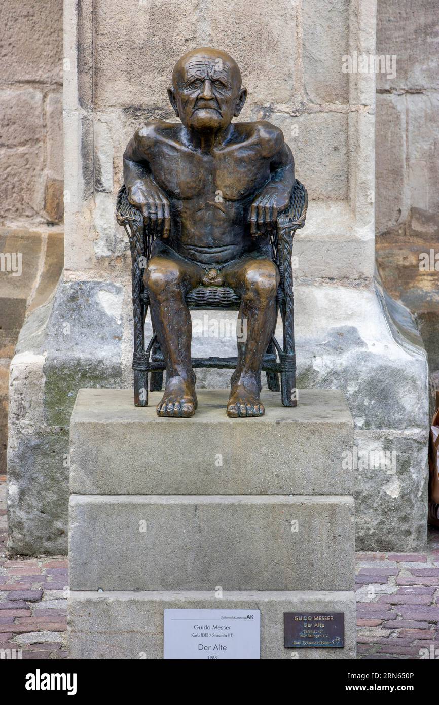 Bronze sculpture The Old Man by Guido Messer in front of the Protestant ...
