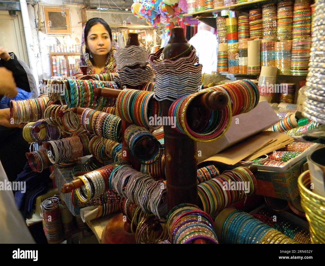 A Pakistani Muslim woman shops at a market ahead of the Muslim festival ...